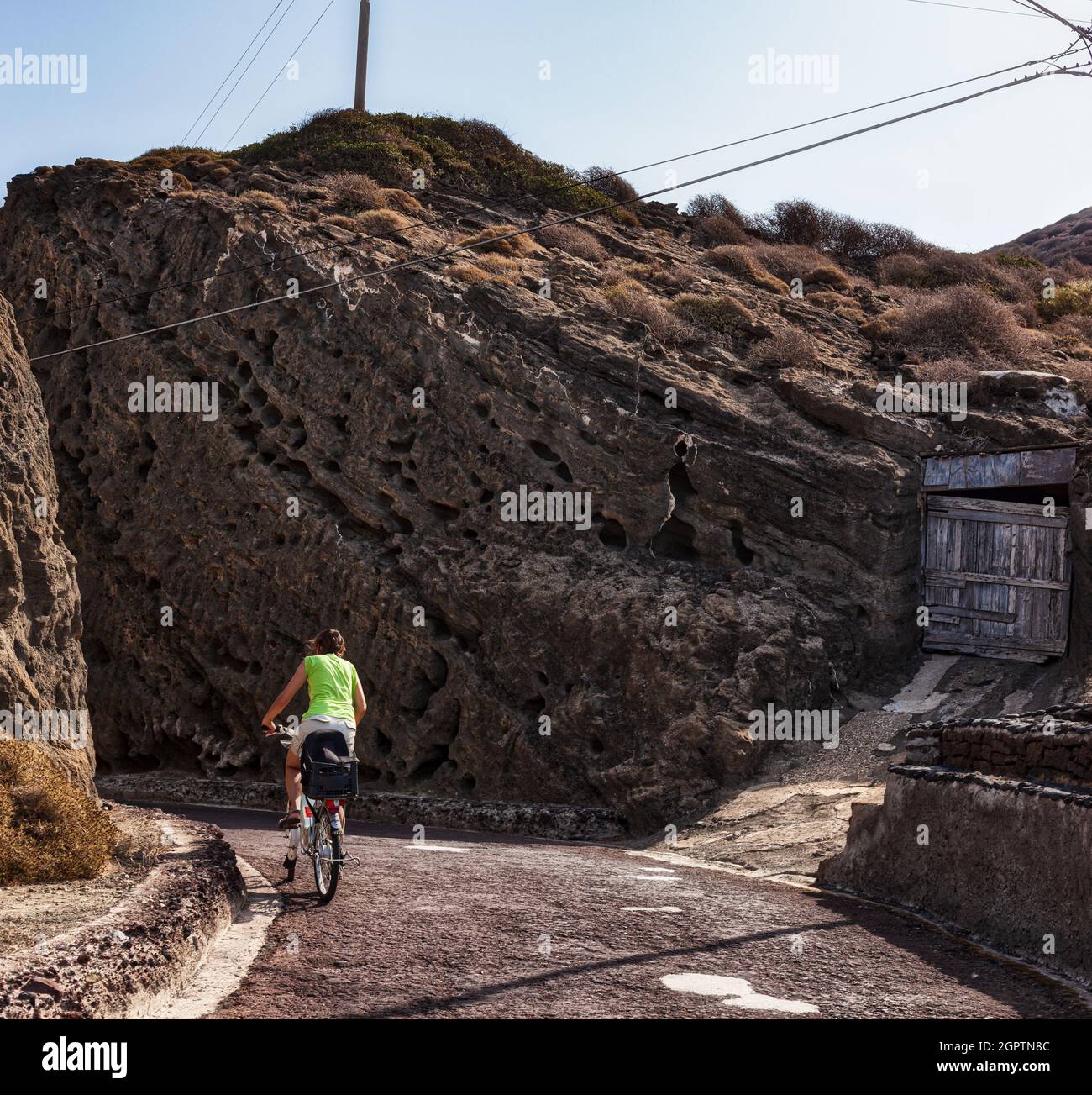 Tour by bike through the streets of Linosa in the summer season, Sicily Stock Photo - Alamy