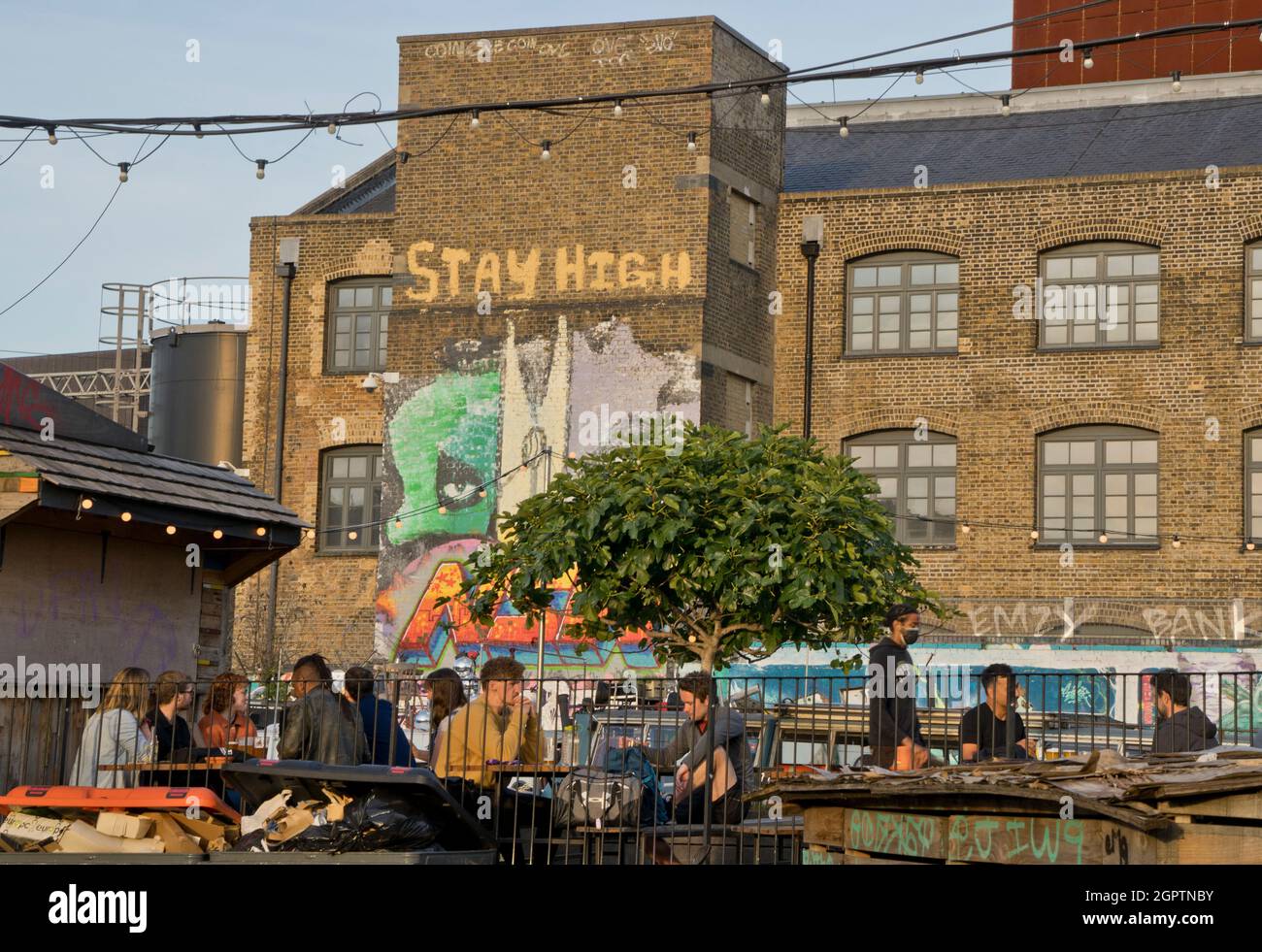 Old pub and warehouse studios by the Lea river canal with graffiti art ...