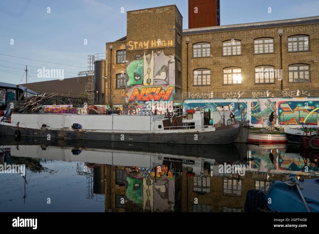 Old pub and warehouse studios by the Lea river canal with graffiti art ...