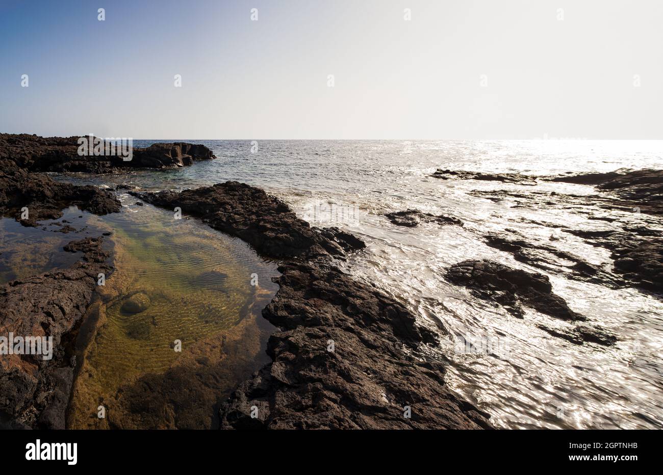 View of the scenic lava rock cliff in the Linosa island. Sicily Stock ...