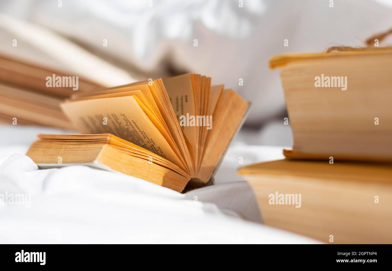 Open book on bedsheet Stock Photo - Alamy