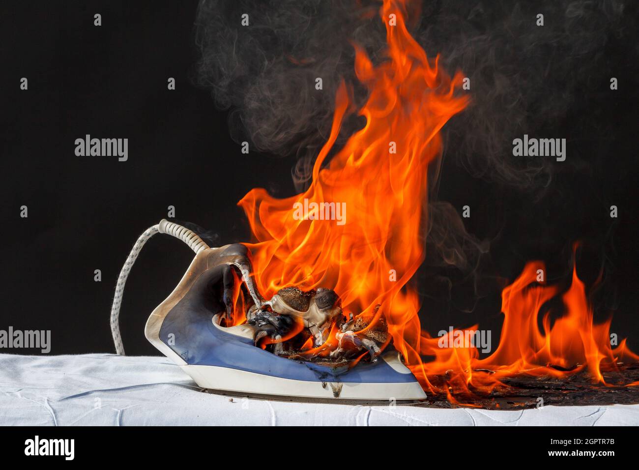 On the ironing board fire caused by faulty electrical wiring Stock ...