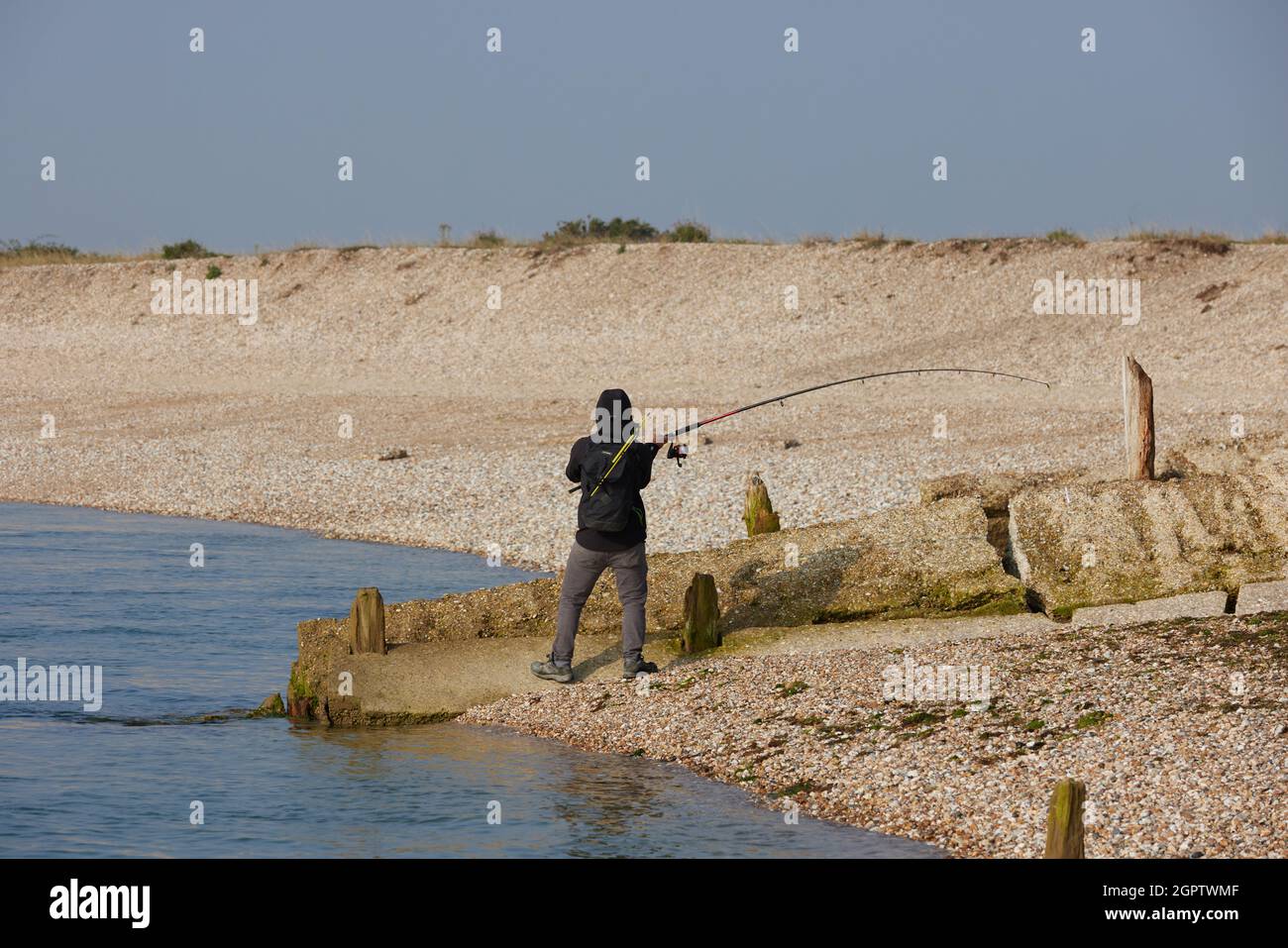 Angler seen beach fishing in Pagham, UK Stock Photo - Alamy