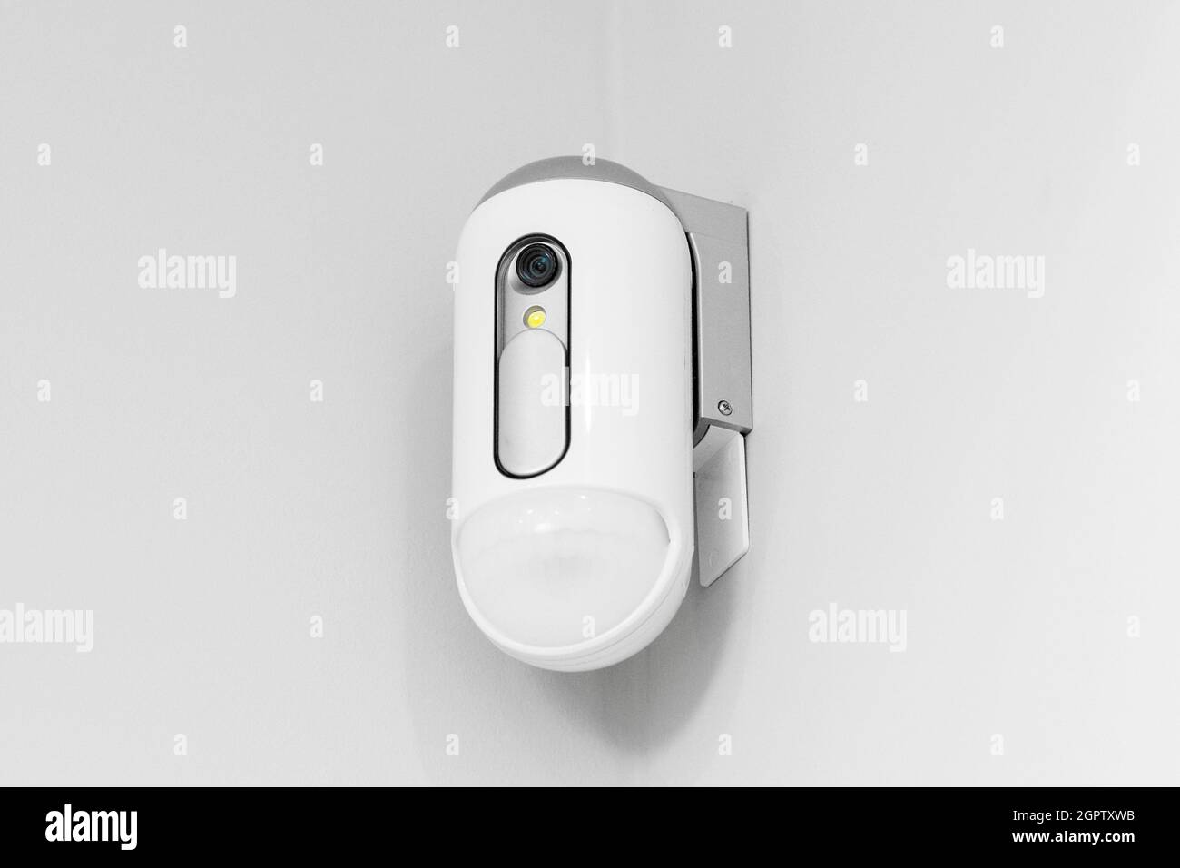 Surveillance camera with presence sensor on the wall Stock Photo - Alamy