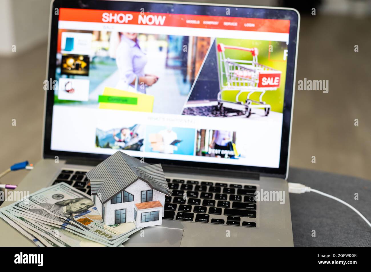 Laptop and dollar bill for Shopping online, home model Stock Photo - Alamy