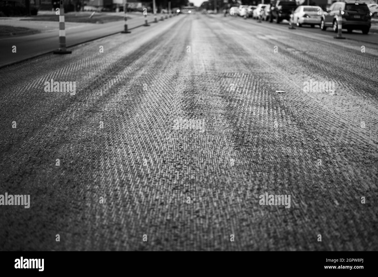 Low angle shot across a scarified street under construction with lanes ...