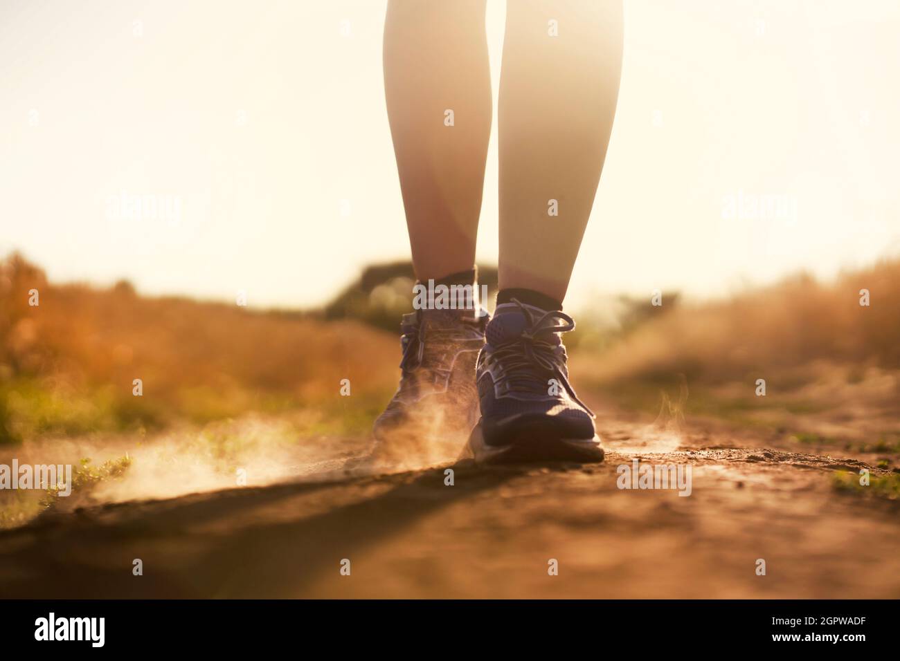 Female athletic legs and dust from the trail close up Stock Photo - Alamy