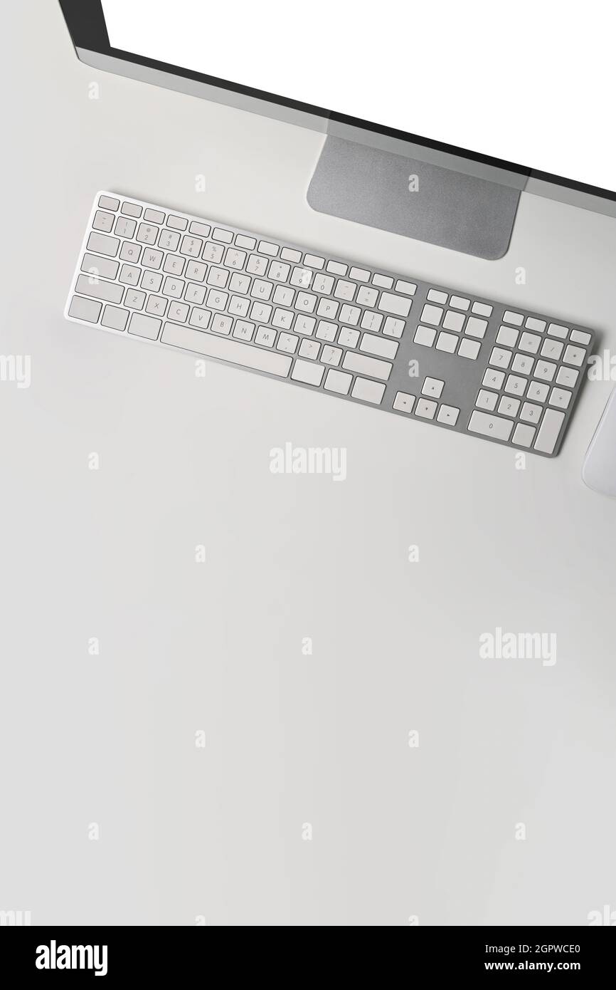 Overhead view computer with blank screen and wireless keyboard on white ...