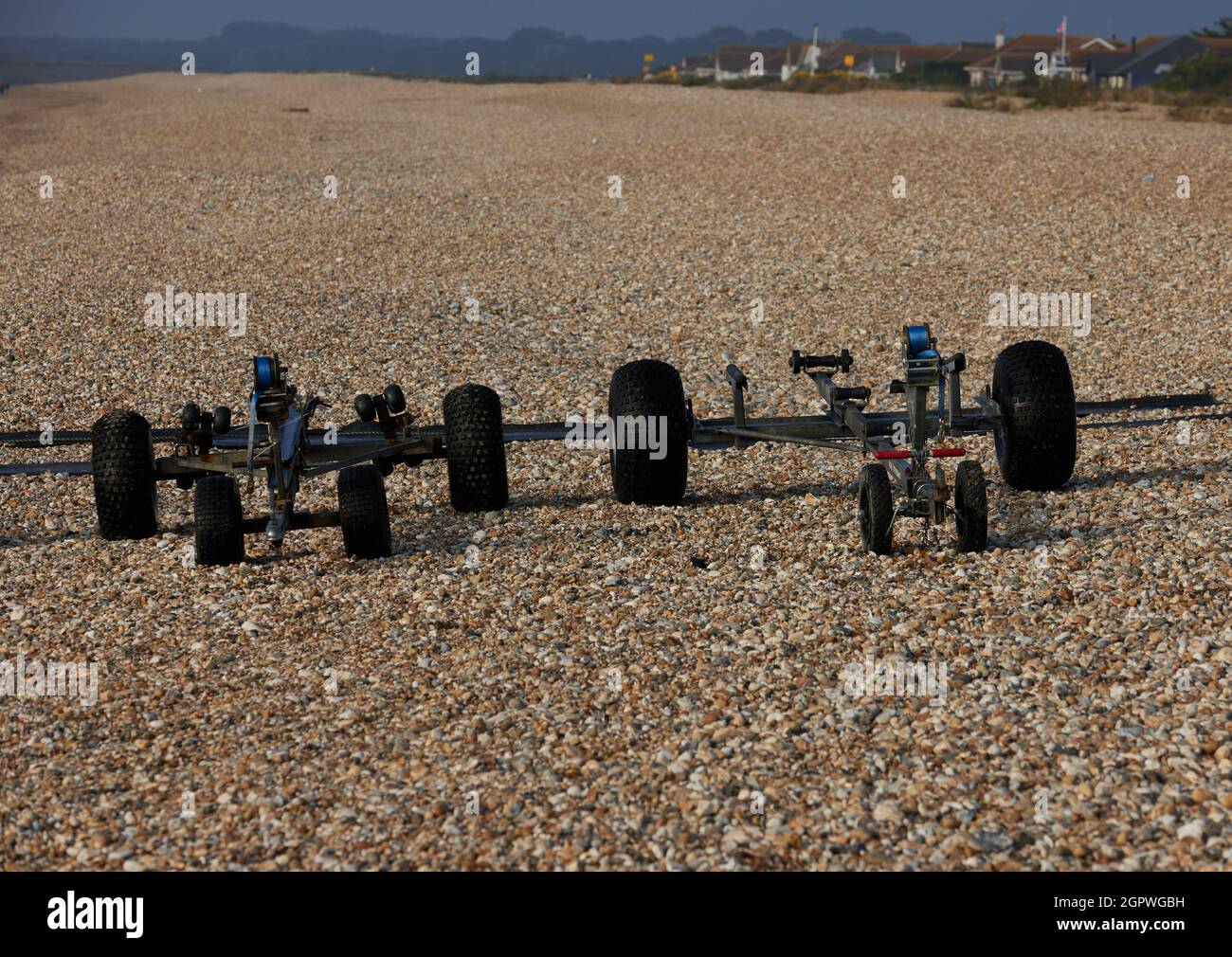 Two boat-carriers seen next to each other on the beach Stock Photo - Alamy