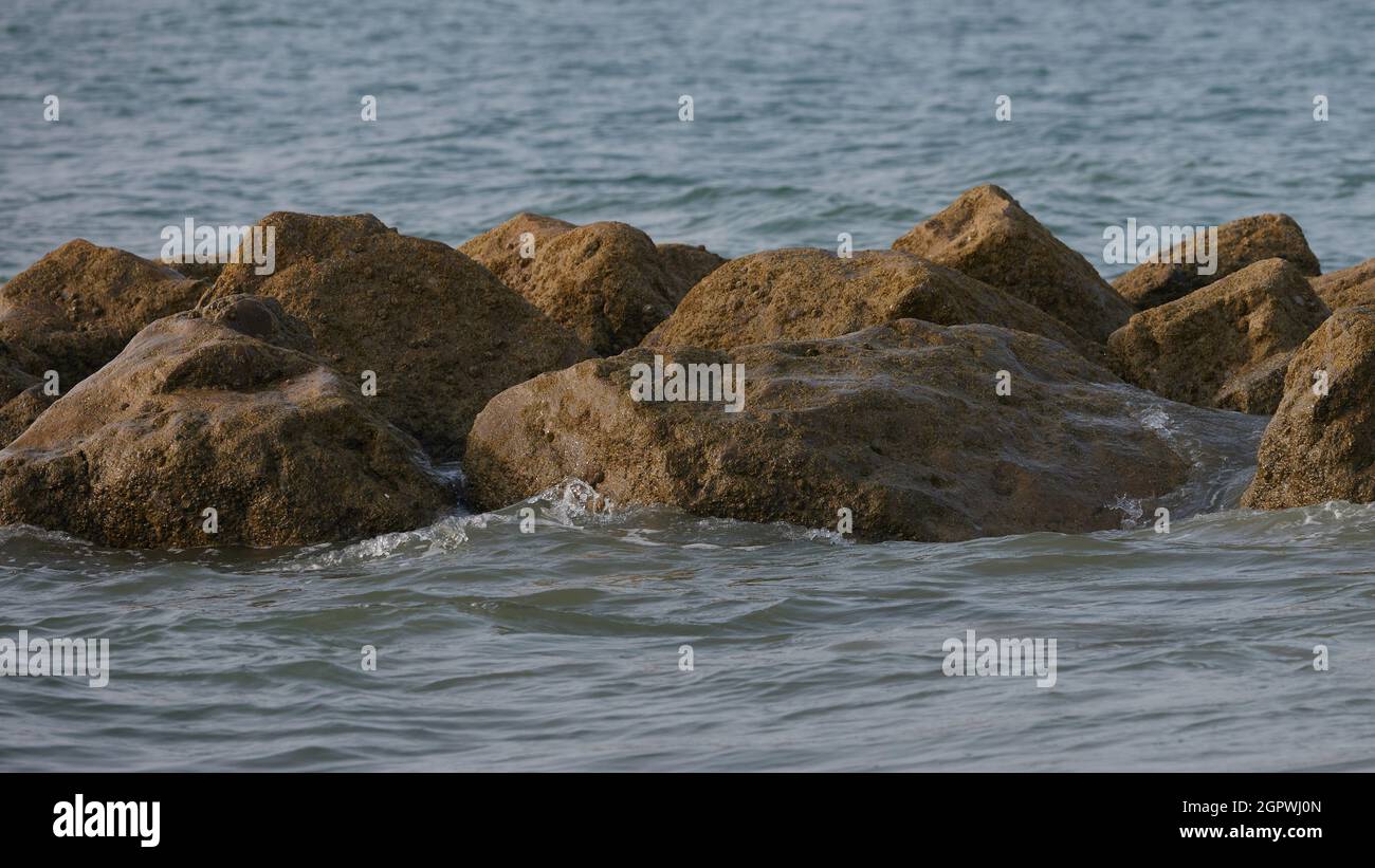 Low level laying group of rocks near the shoreline Stock Photo - Alamy