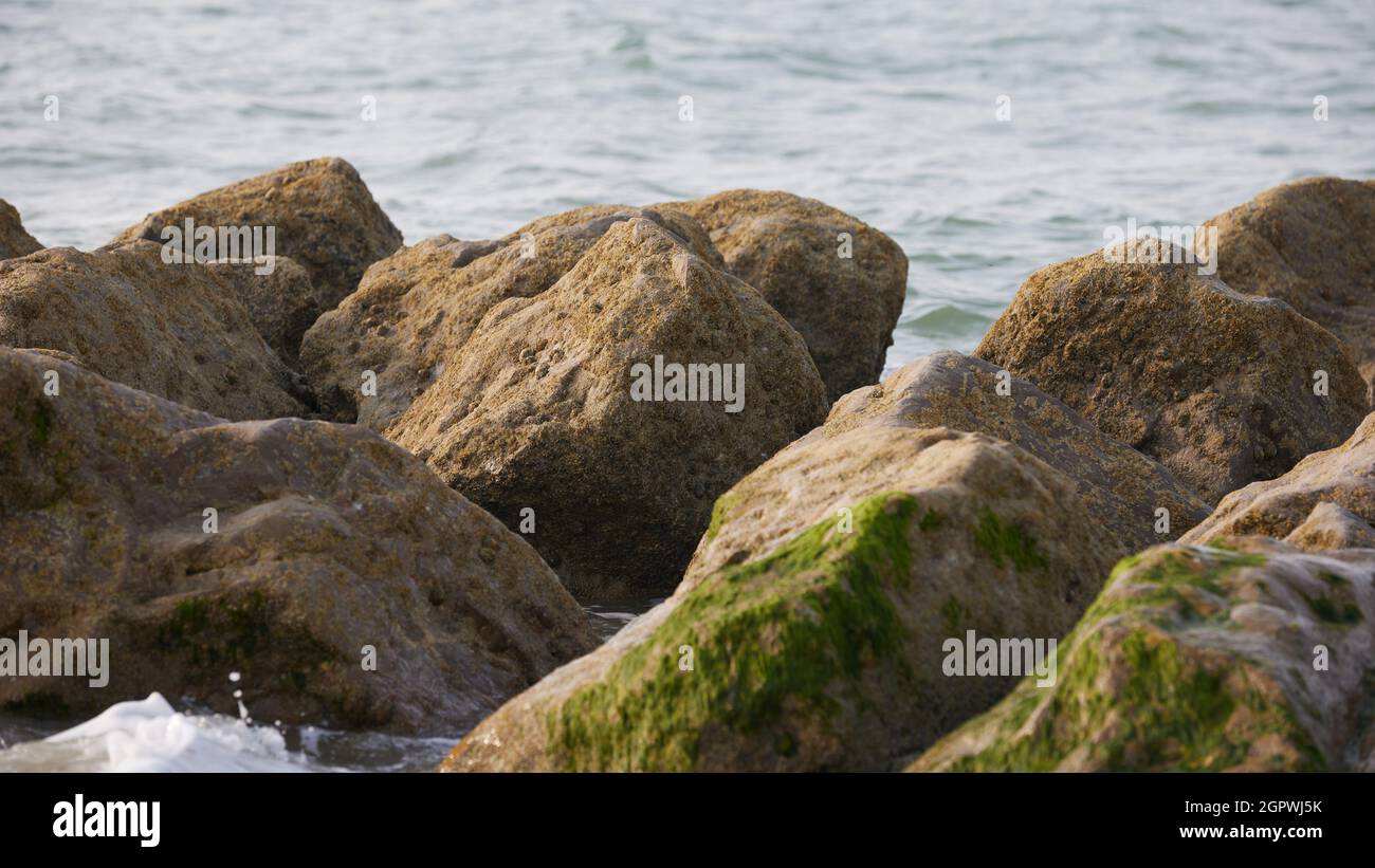 Low level laying group of rocks near the shoreline Stock Photo - Alamy