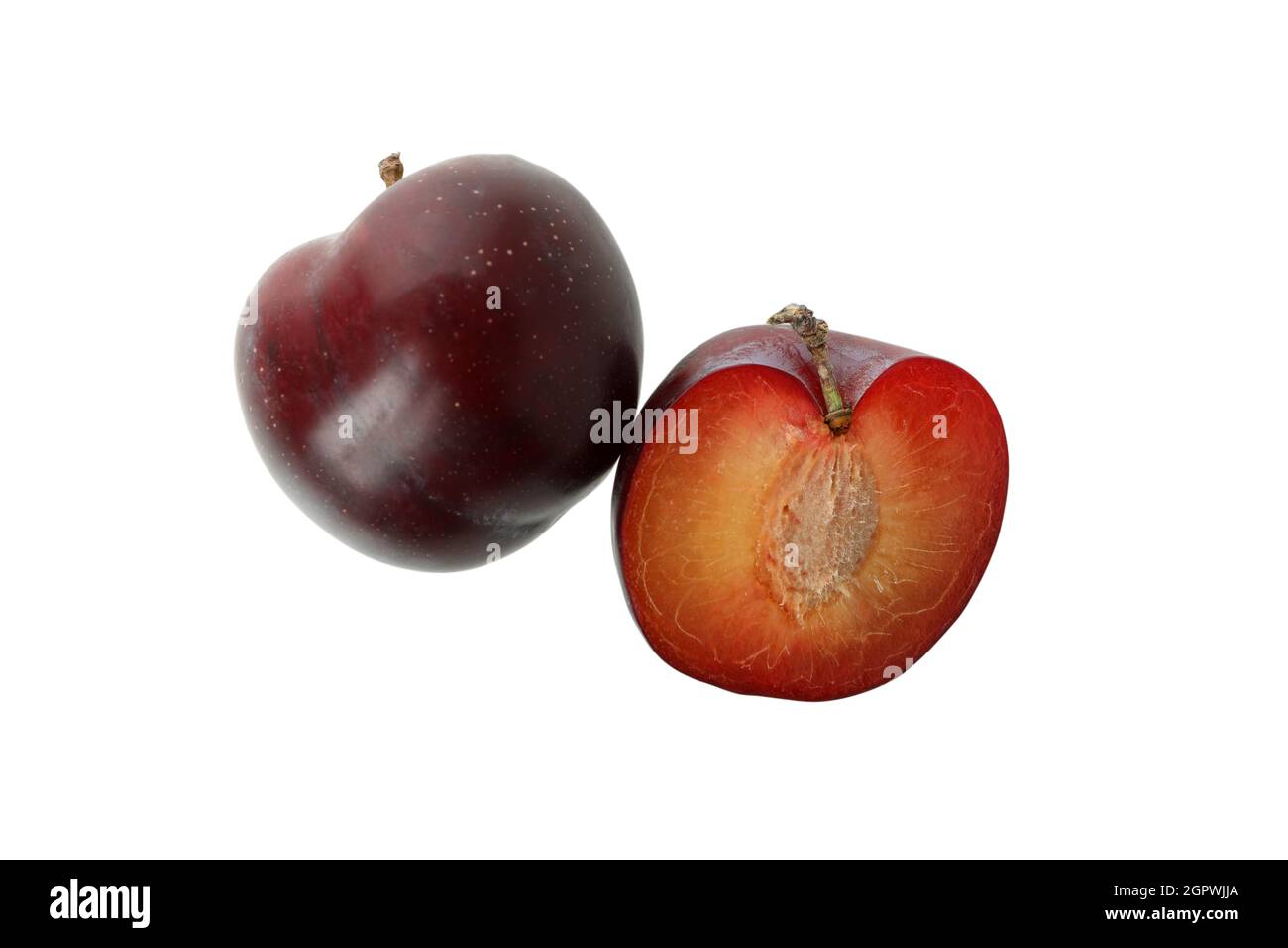 Plum with half isolated on white background Stock Photo - Alamy