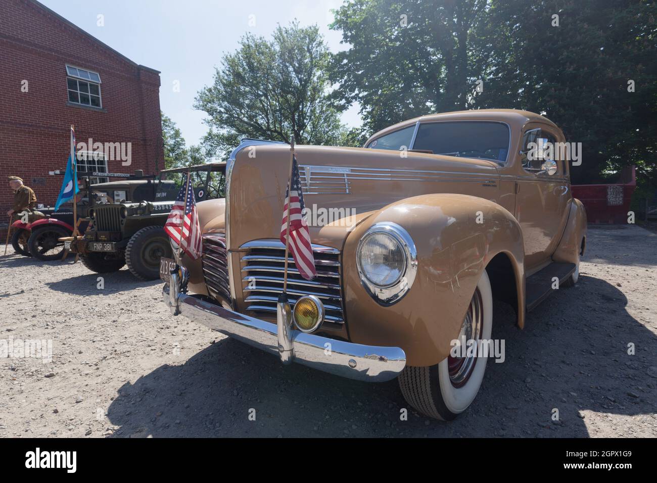 American Hudson Eight Vintage car with American flags beige colour ...