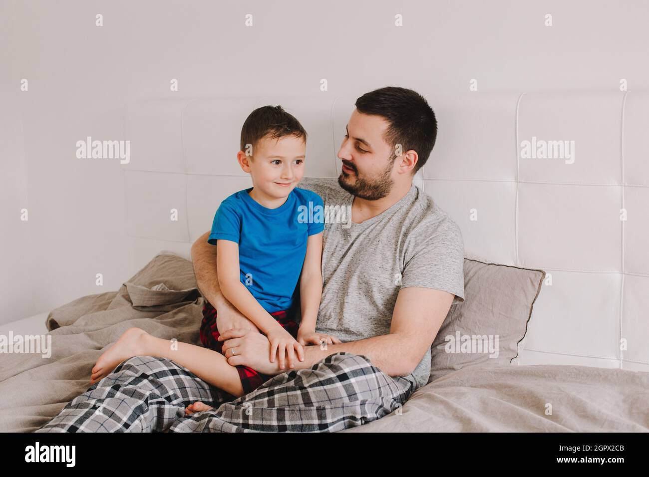 Boy embracing sitting on lap hi-res stock photography and images - Alamy