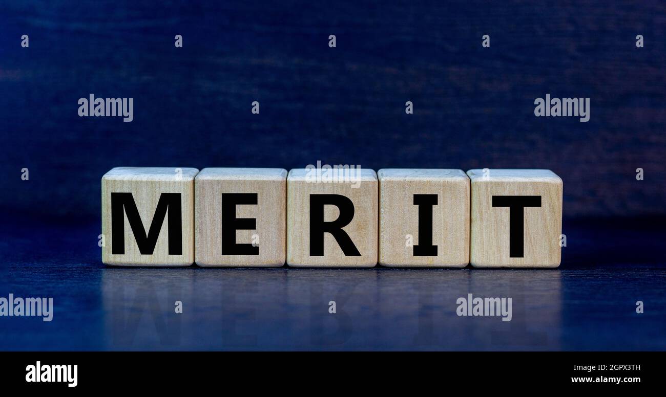 Merit symbol. The concept word 'merit' on wooden cubes on a beautiful ... Merit symbol. The concept word 'merit' on wooden cubes on a beautiful ...