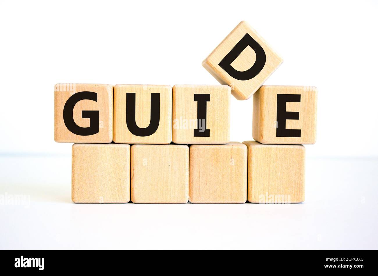 Guide and support symbol. The concept word 'guide' on wooden cubes on a ...