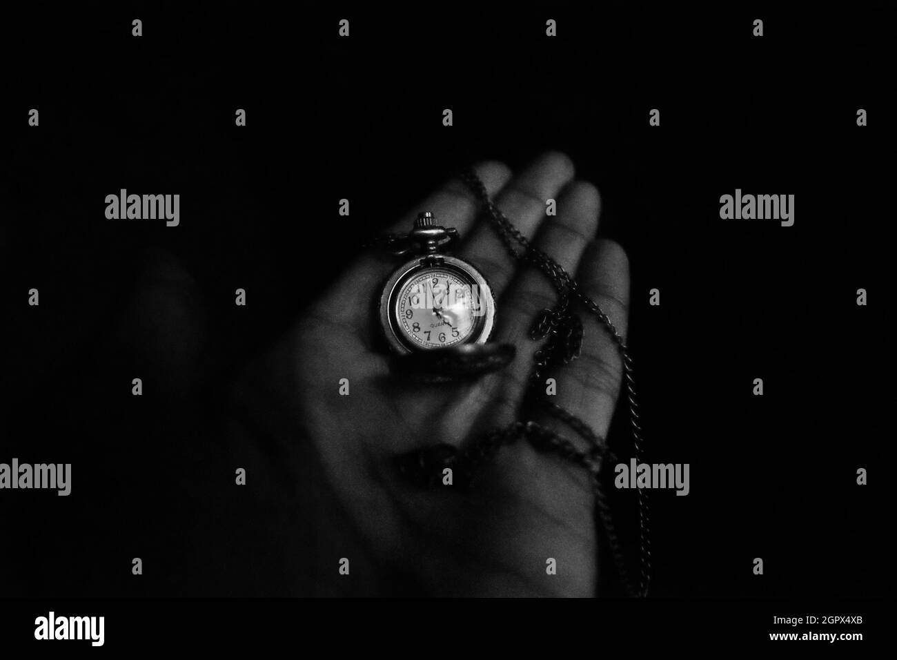 Hand holding pocket watch Black and White Stock Photos & Images - Alamy