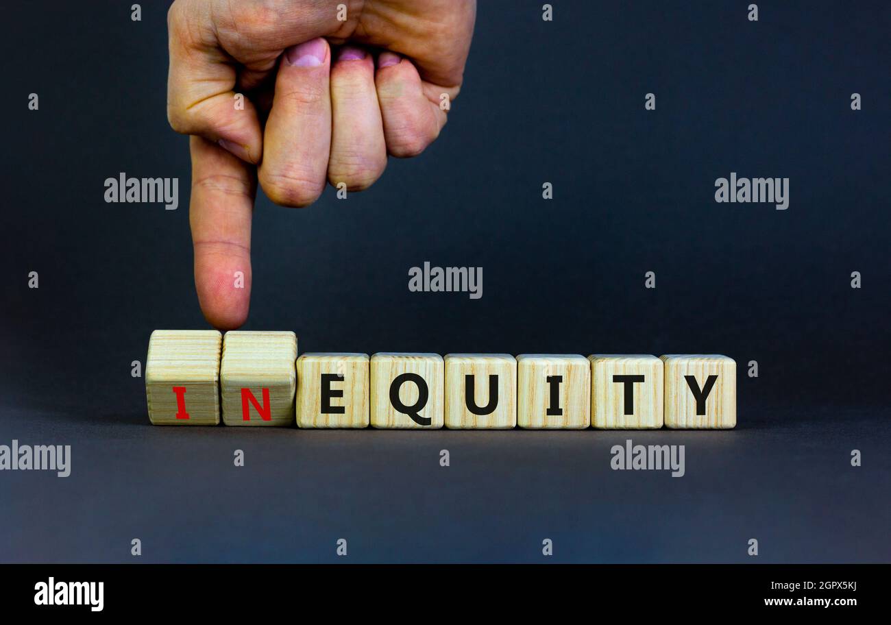 Inequity or equity symbol. Businessman turns wooden cubes and changes ...