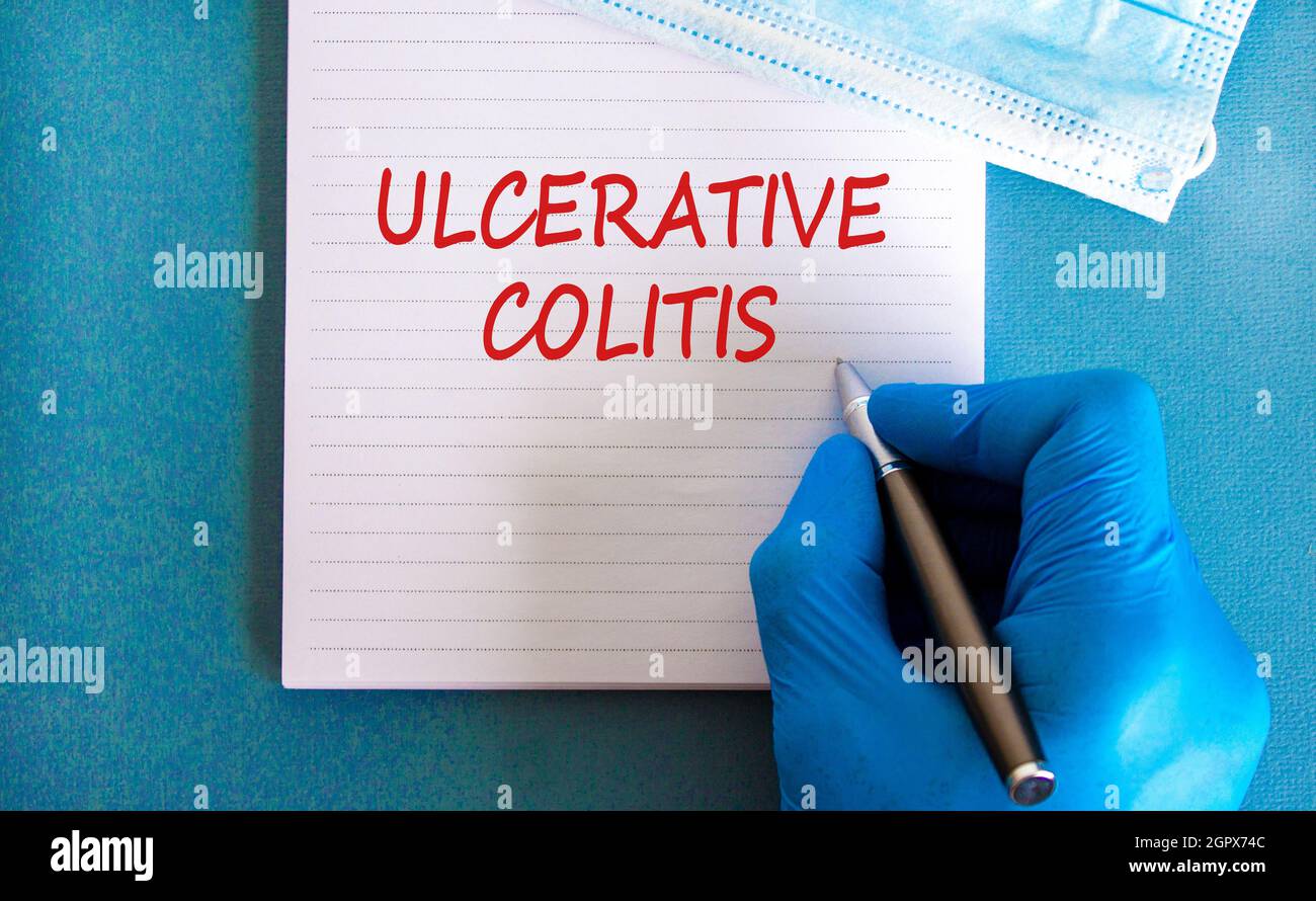 Ulcerative colitis symbol. White note with words Ulcerative colitis ...