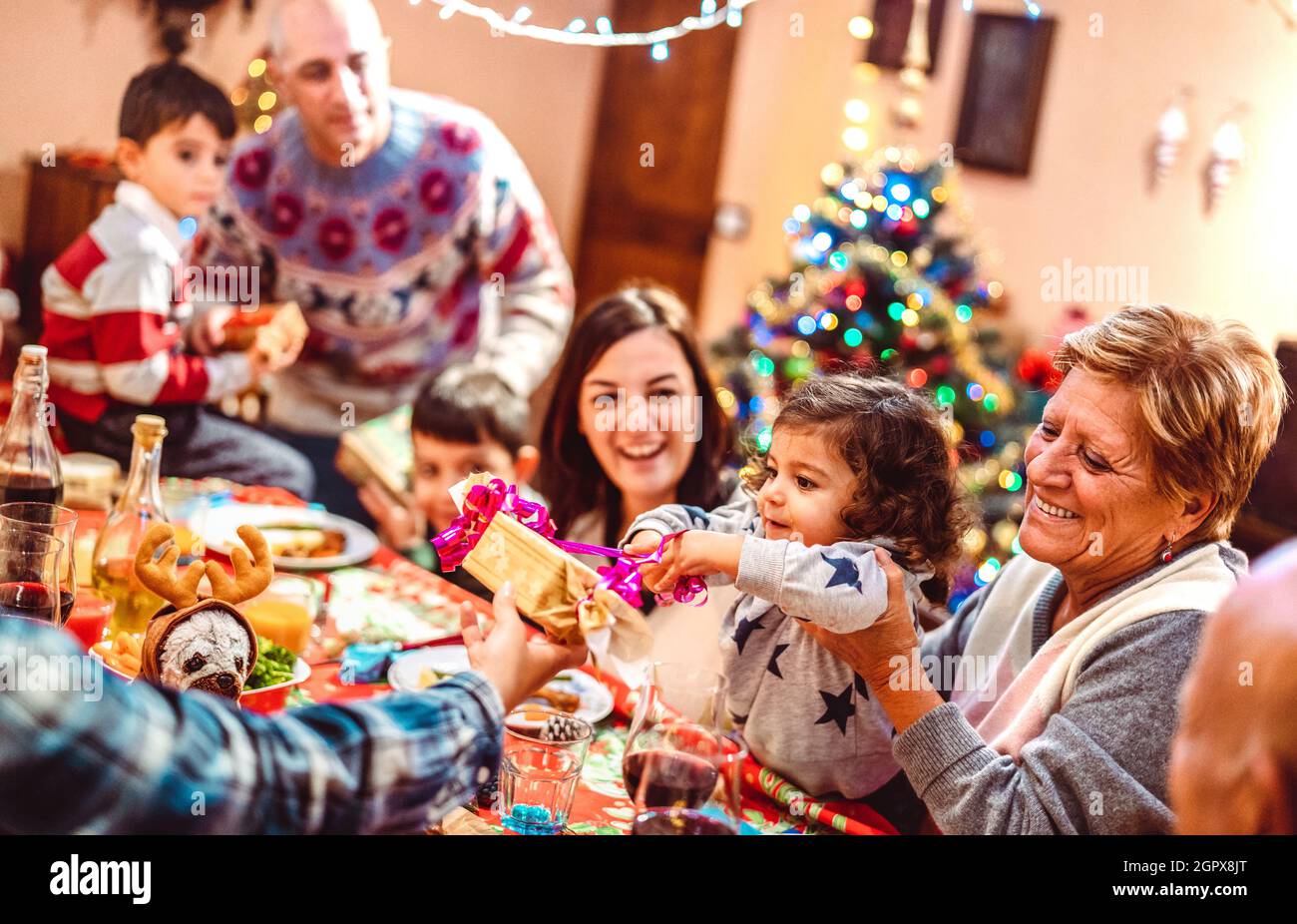Multi generation big family having fun at christmas supper party ...