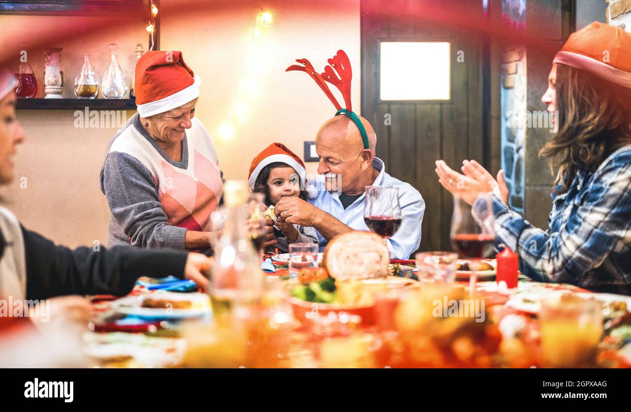Large multi generation family having fun at christmas supper party ...