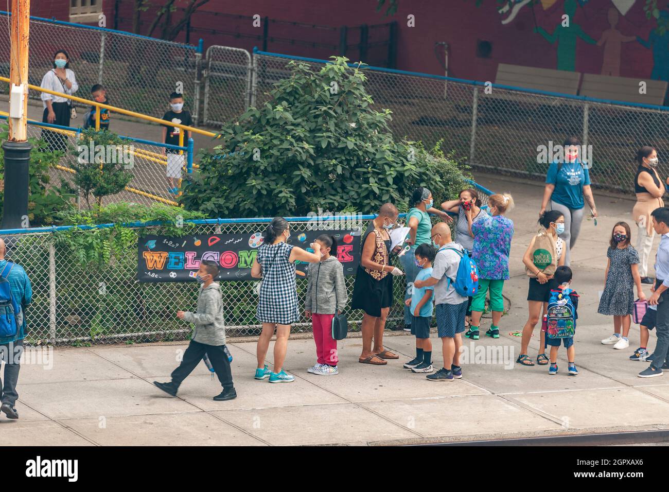 Parents and students line up outside of PS33 in Chelsea in New York on ...