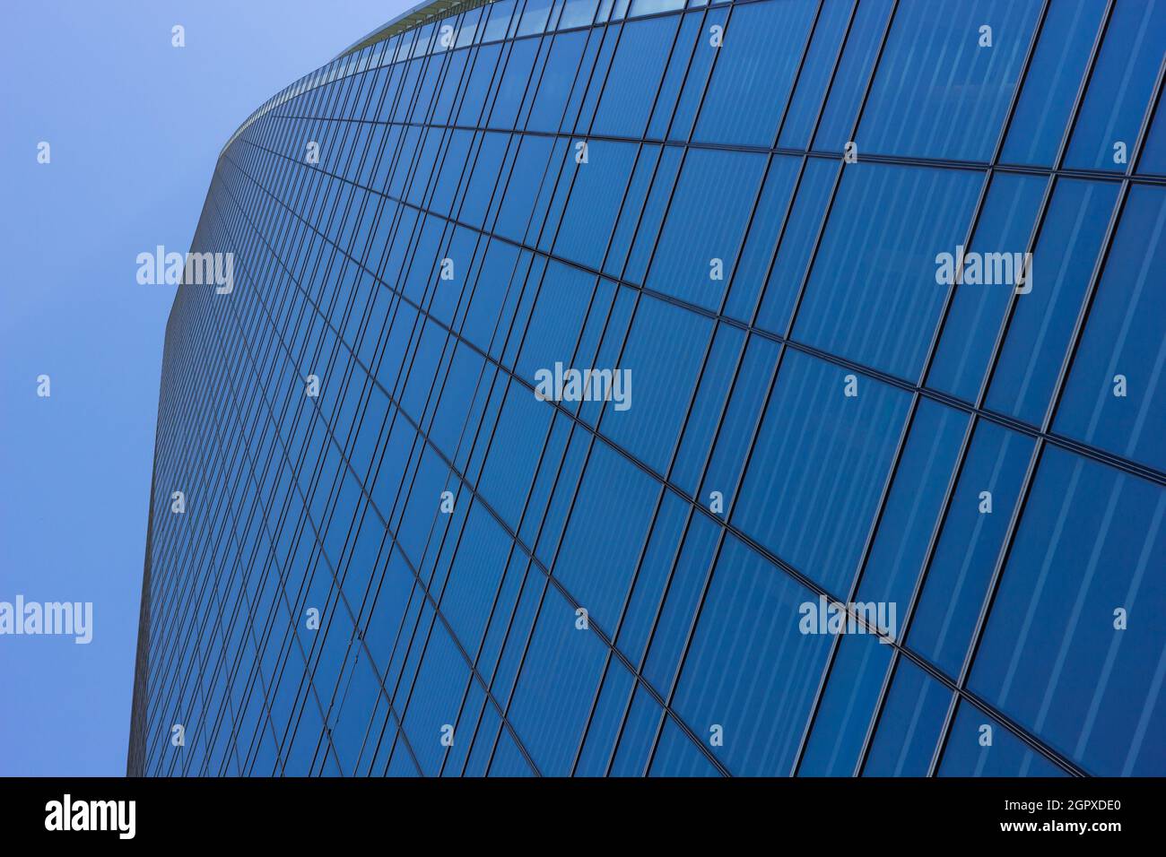 Angle perspective of glass skyscraper view from below. Financial blue ...