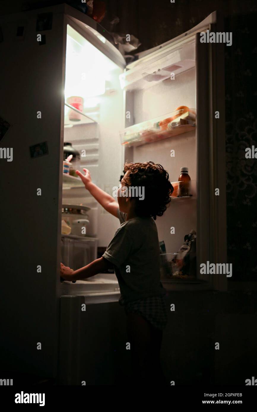 Boy looking in refrigerator hi-res stock photography and images - Alamy