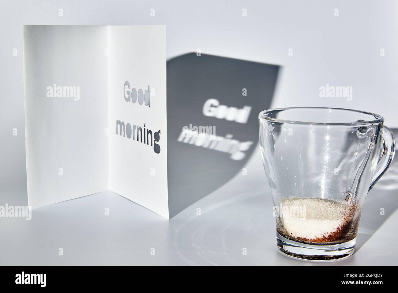 A cup of instant coffee and sugar and a good morning greeting card ...