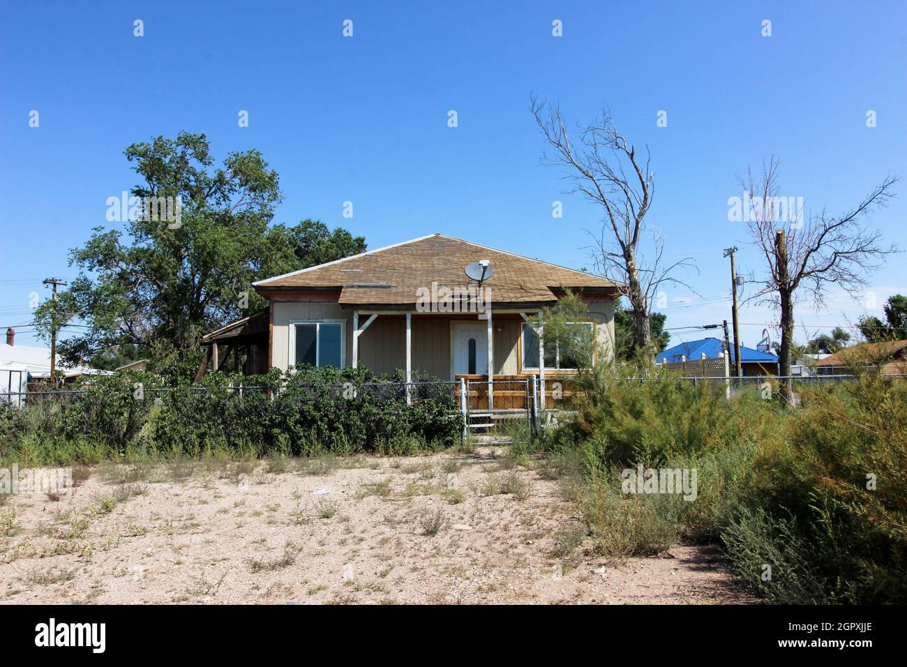 Overgrown Weeds Around Abandoned One Level Home Stock Photo - Alamy