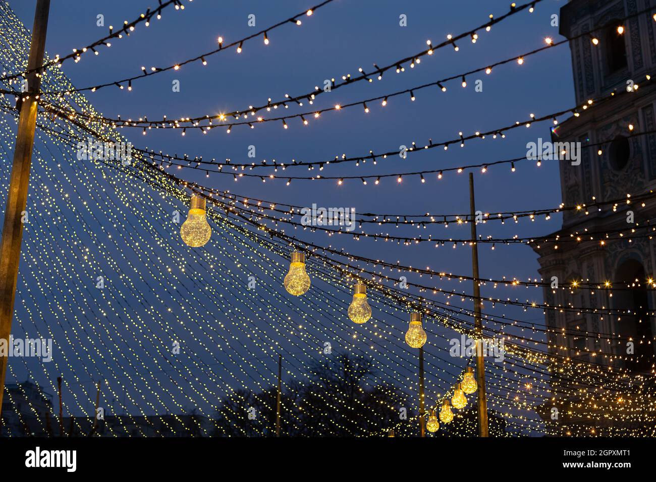 Stylish illuminated tree with warm golden lights, festive decor of ...