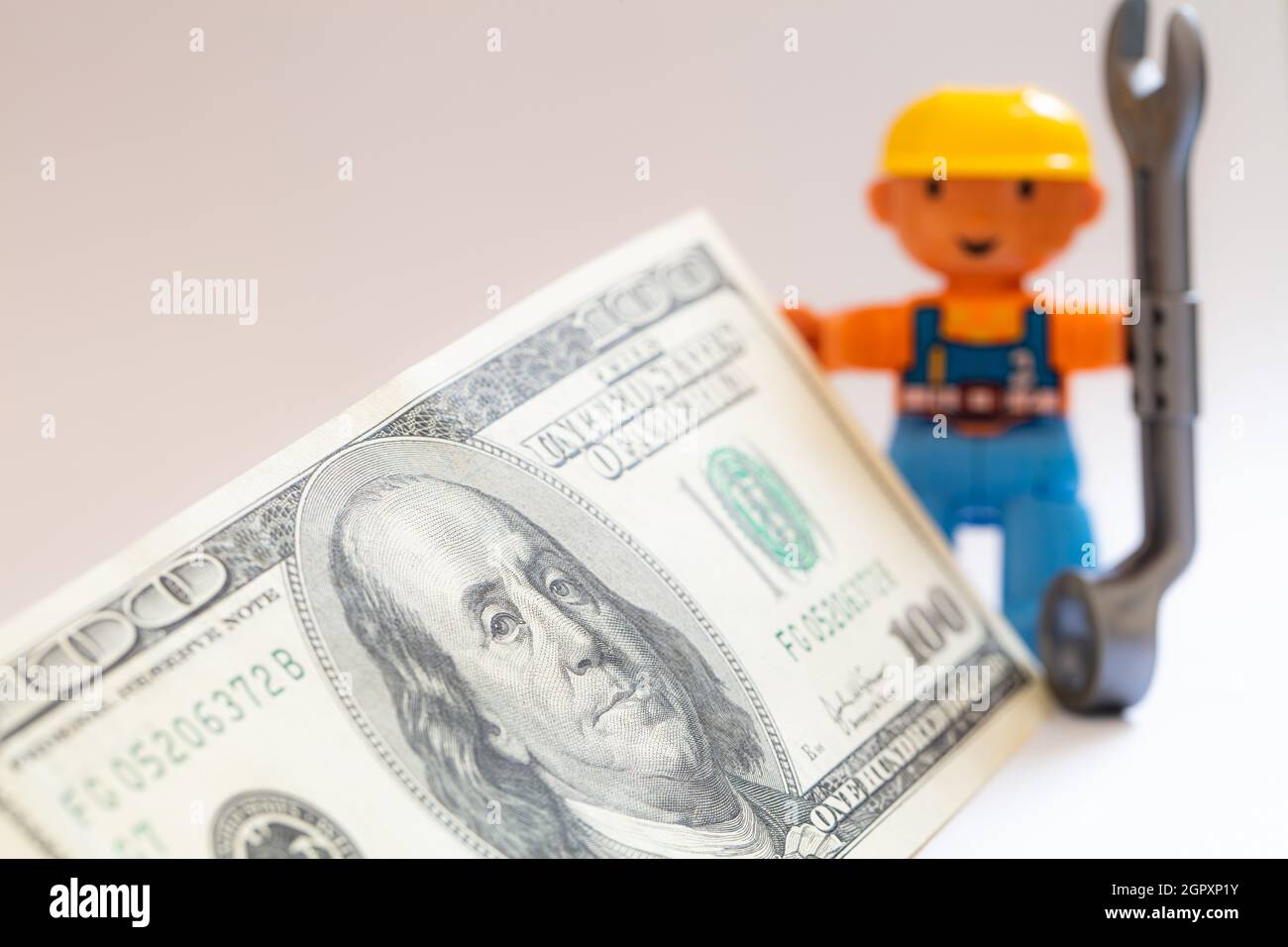 Small man figurine with 100 dollar banknote for design purpose Stock ...