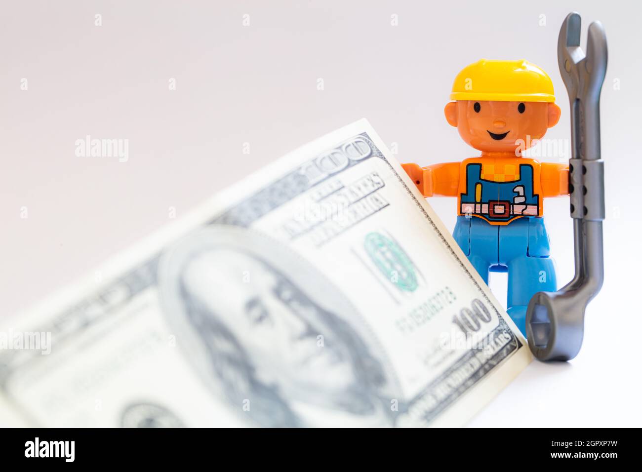 Small man figurine with 100 dollar banknote for design purpose Stock ...