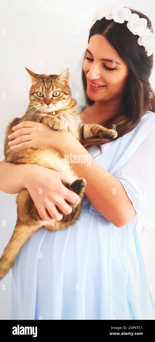 Beautiful Woman Carrying Cat At Home Stock Photo - Alamy