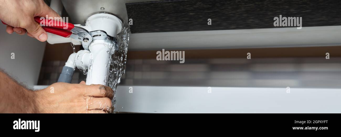Plumber Fixing Water Leak Close Up. Pipe Plumbing Stock Photo - Alamy