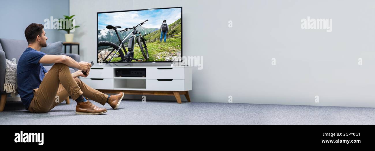 Man Watching Connected TV Screen In Living Room Stock Photo - Alamy