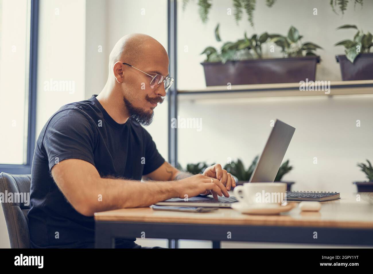Millennial caucasian man works on computer at home office. Distance Job ...