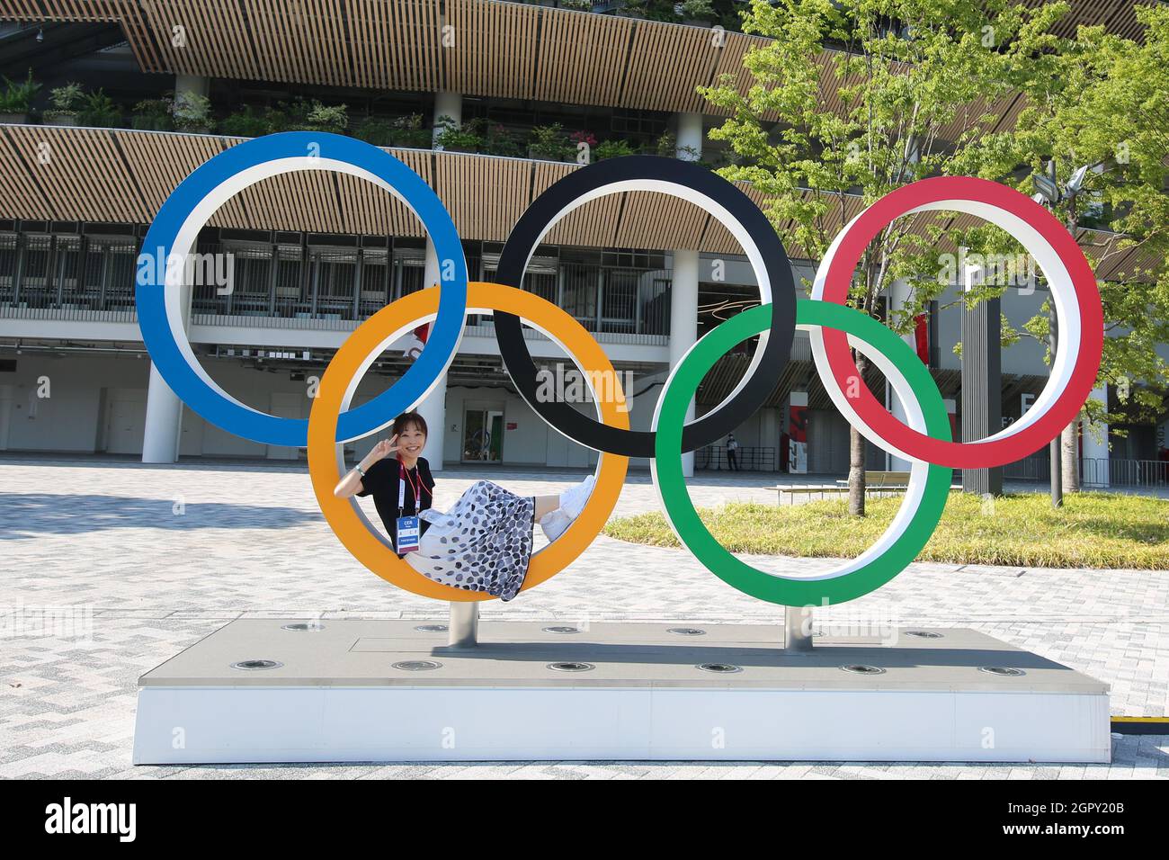 JULY 23rd, 2021 - TOKYO, JAPAN: a volunteer strikes a pose inside the ...