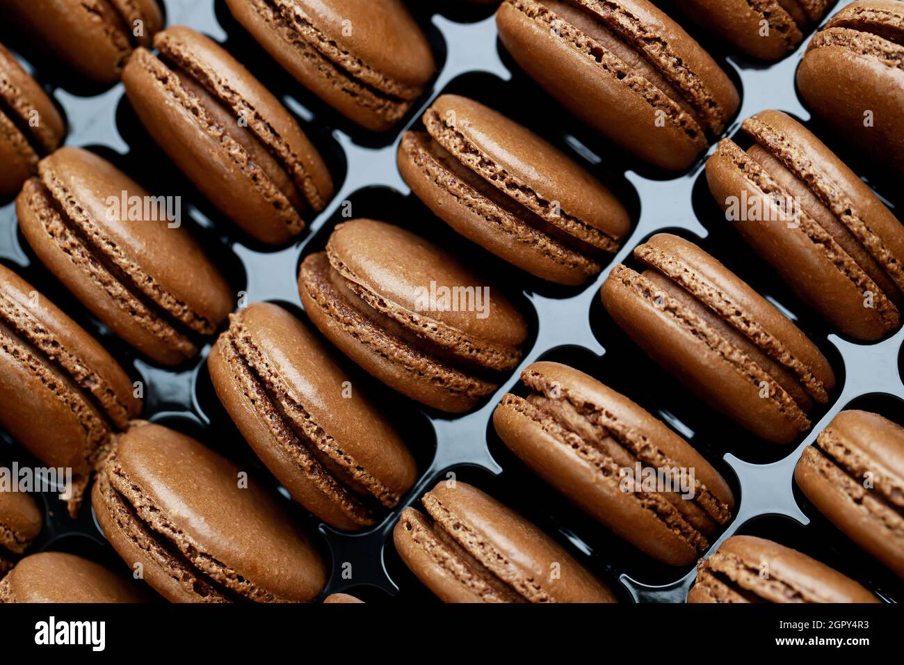 Chocolate-flavored French Macarons Are In The Bakery Stock Photo - Alamy