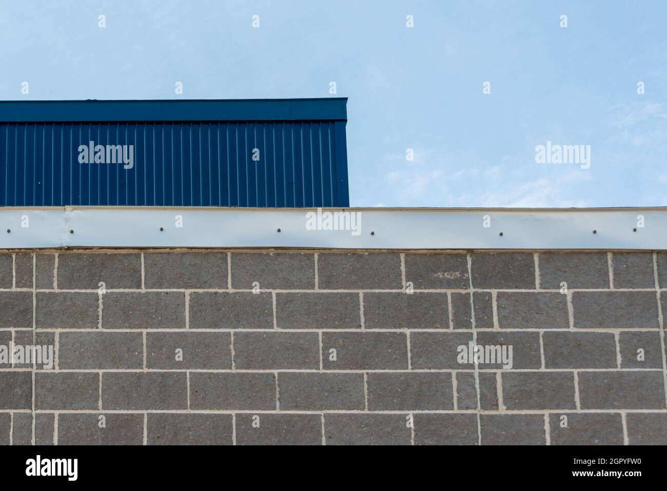 The exterior wall of a commercial building with grey brick, light gray ...