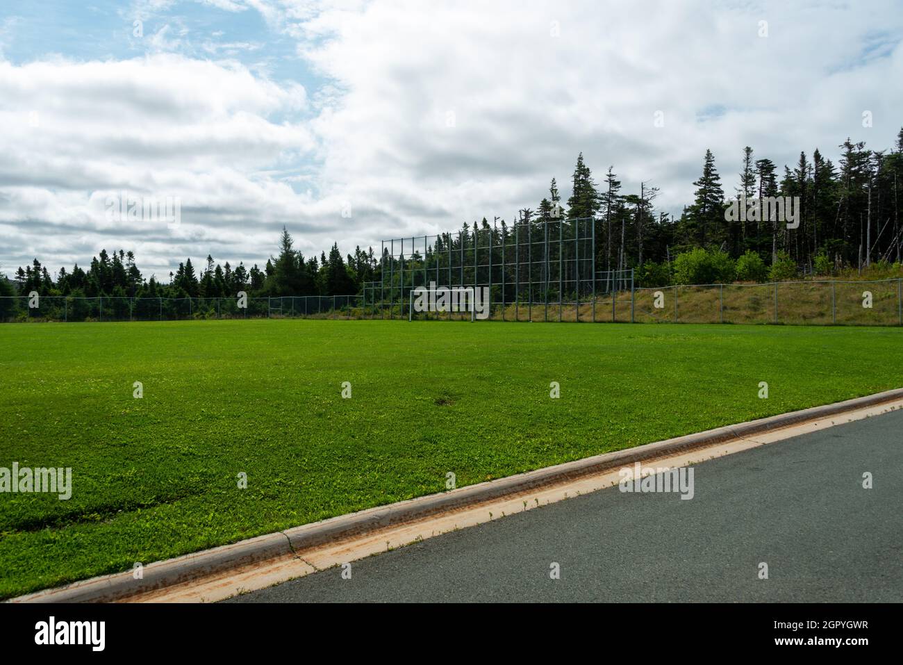 A large soccer field covered in natural green grass outdoors under a ...
