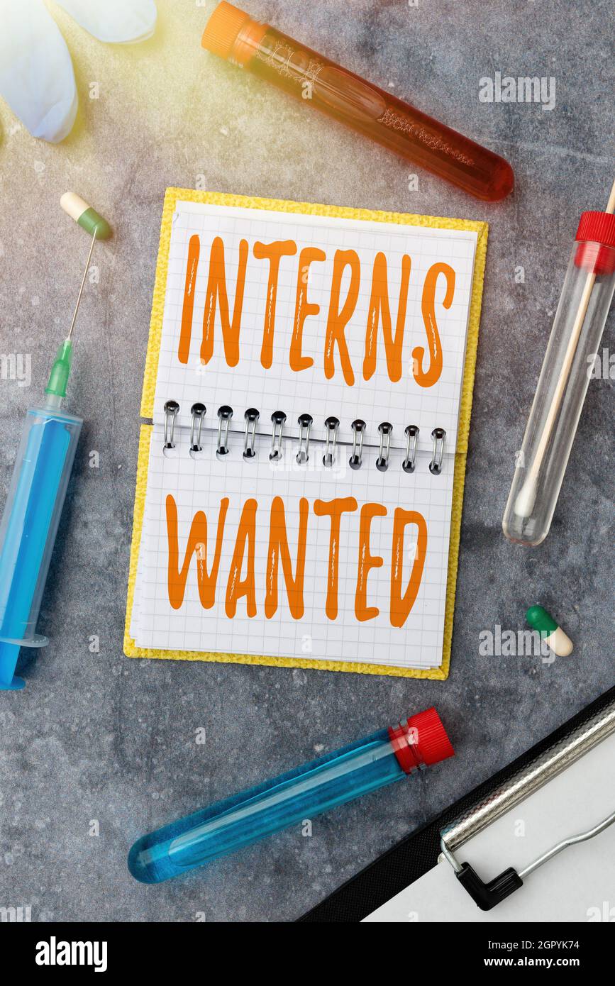 Hand writing sign Interns Wanted. Conceptual photo Looking for on the ...