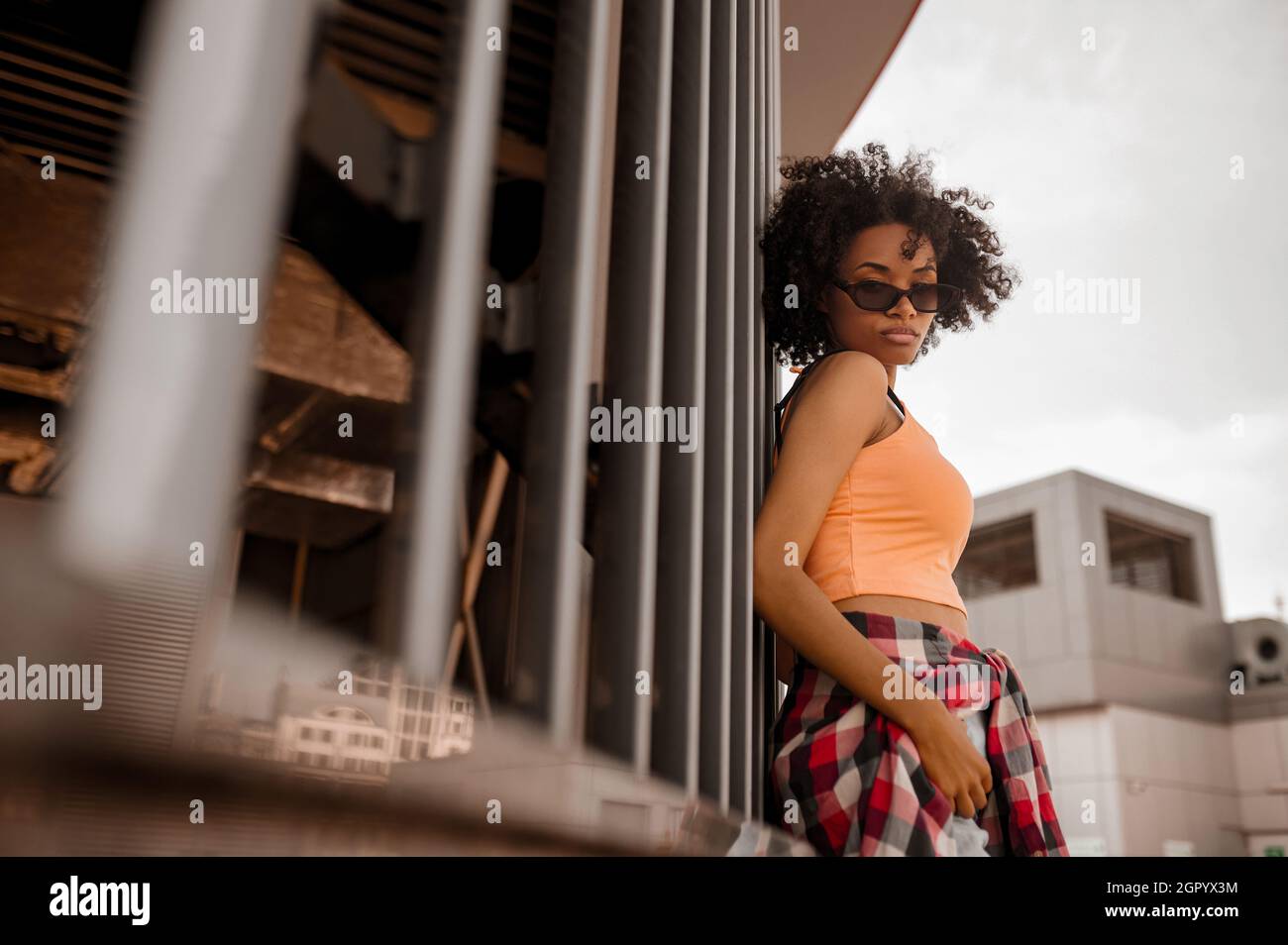Curly-haired cute young mulatta in the city street Stock Photo - Alamy
