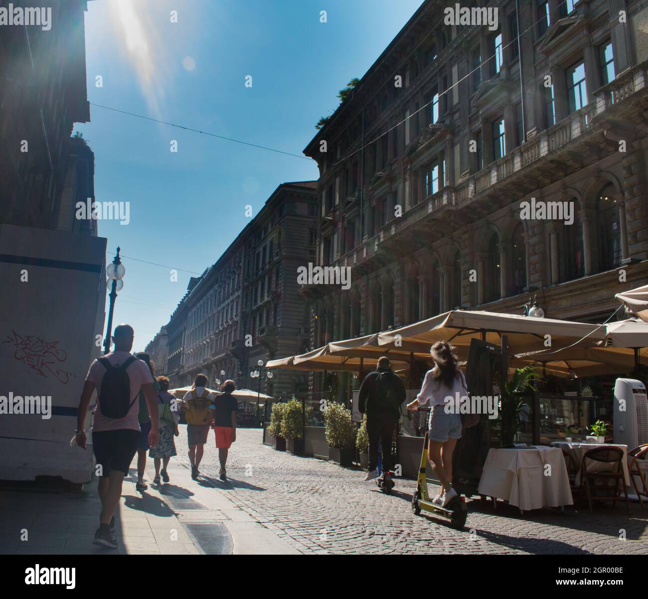 Couple on Electric Scooters on busy street in Milan, Italy. Porto Nuovo ...