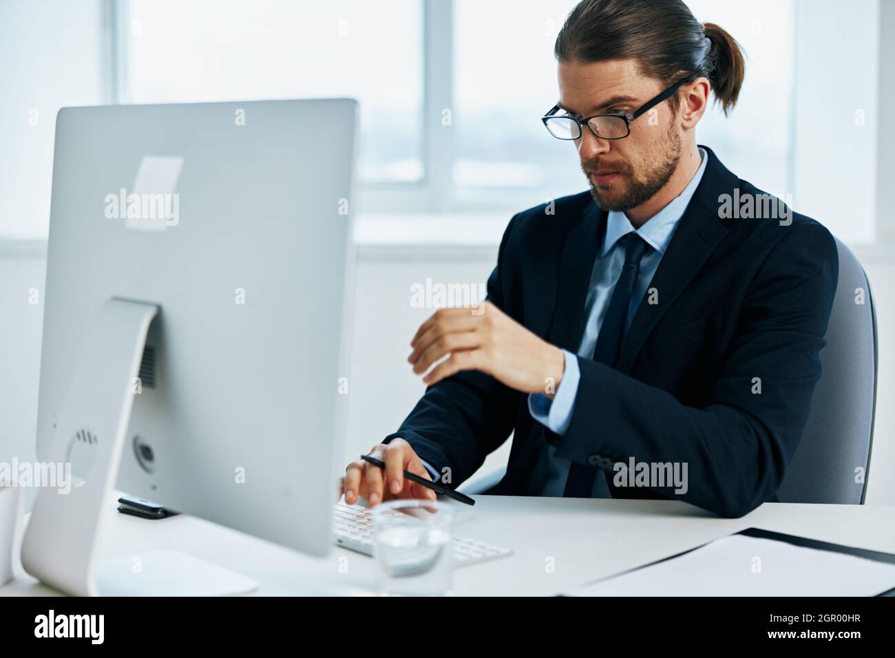 office worker work in front of a computer documents Chief Stock Photo ...