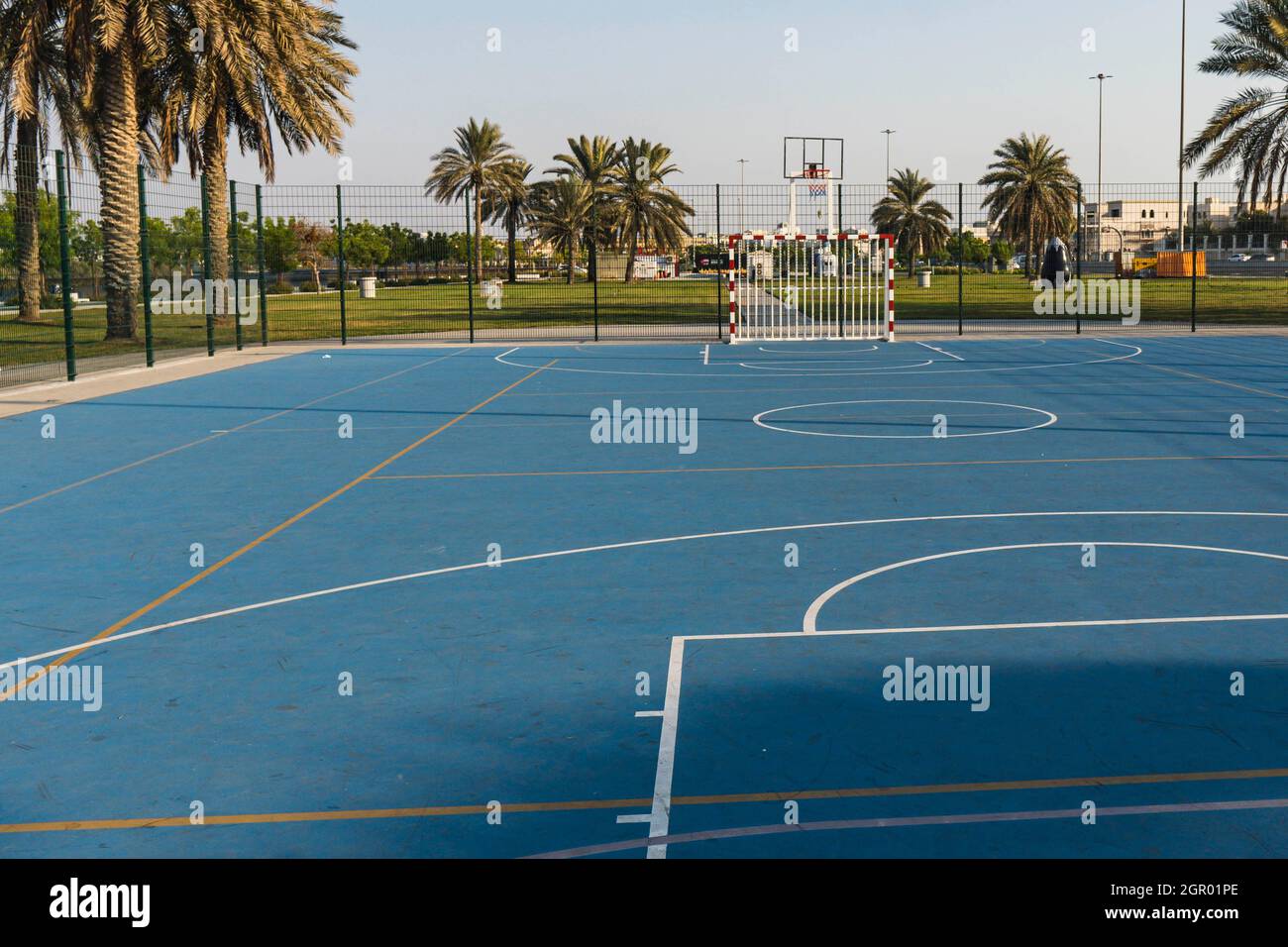 Bright blue soccer and basketball court outside for children sports and ...
