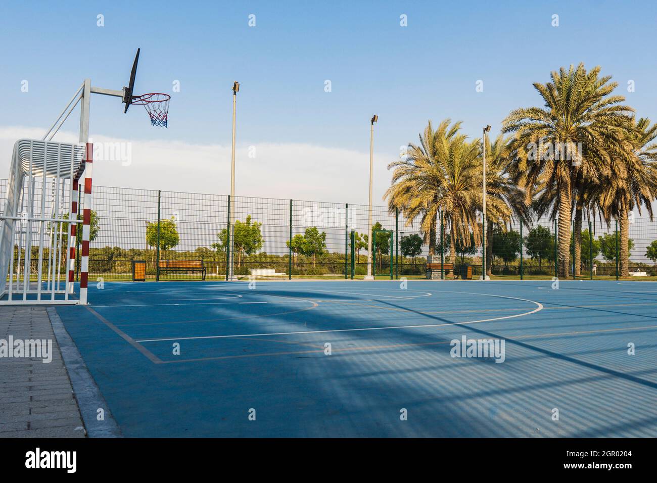 Side view Bright blue soccer and basketball court outside for children ...