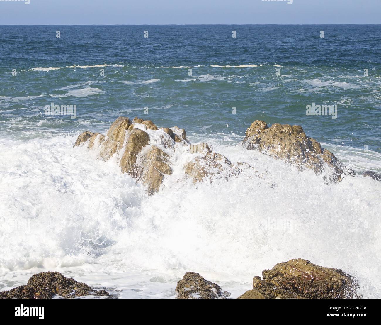 Ocean water splashing on the rock formations on the coast Stock Photo ...