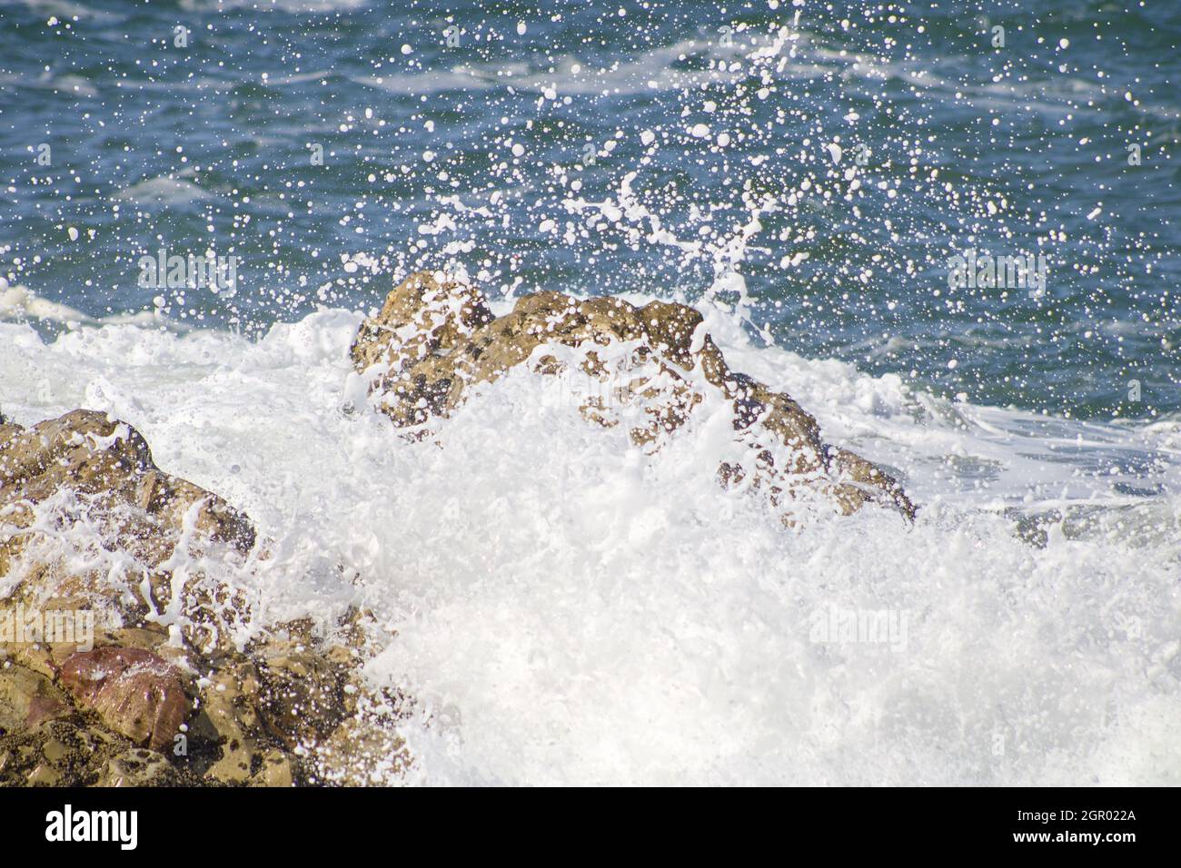 Ocean water splashing on the rock formations on the coast Stock Photo ...