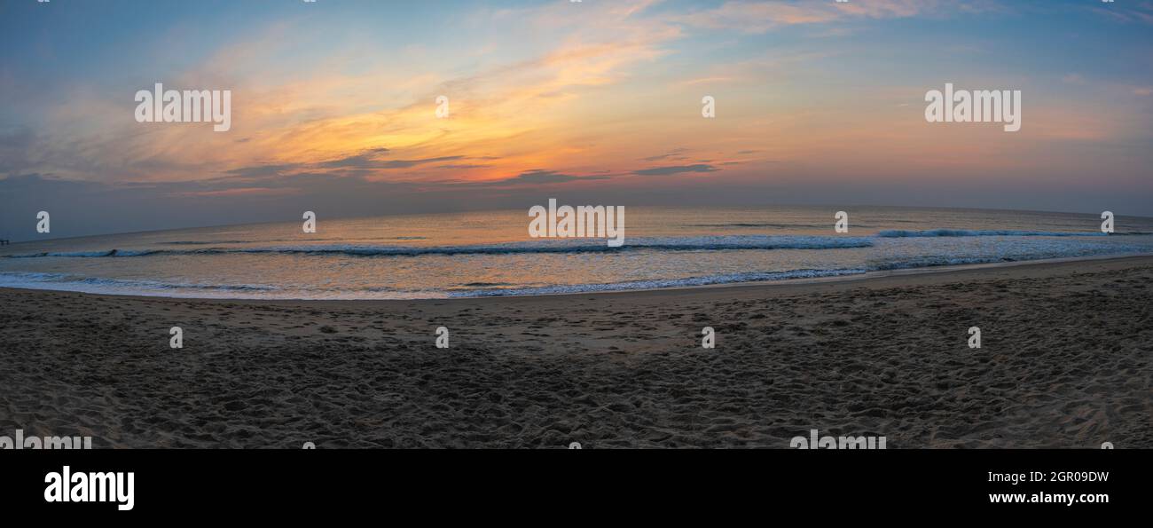 A panoramic photo of Olde Duck beach taken at dawn as the sun rises ...